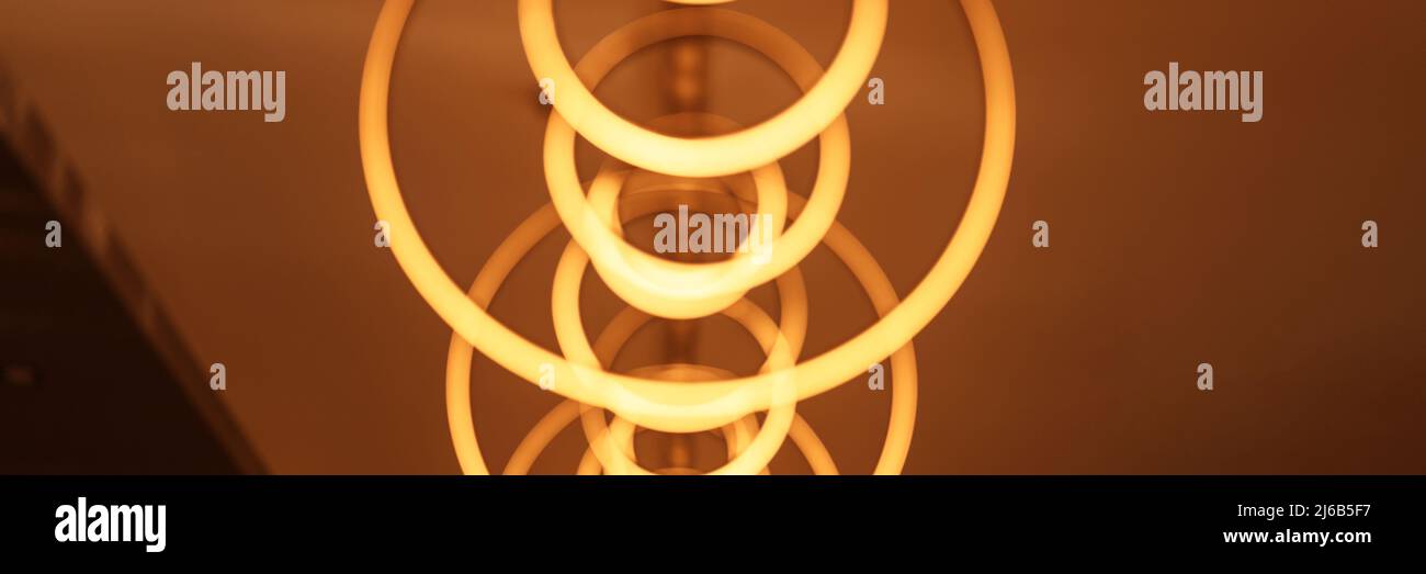 blurred hanging lamp bulb in the form of rings. blur beautiful abstract ...