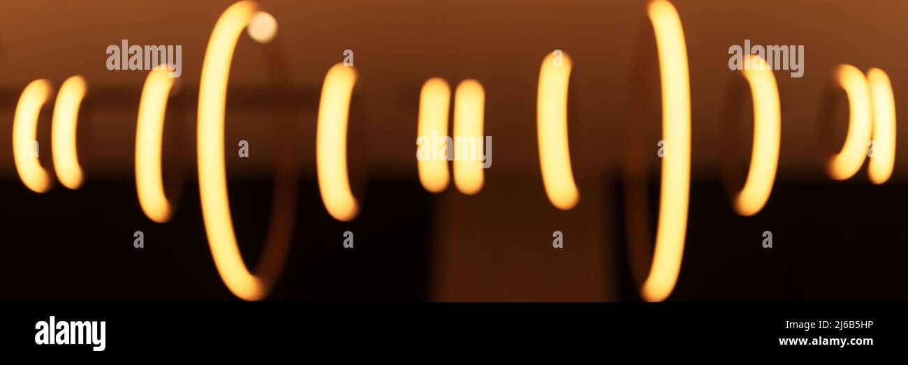 blurred hanging lamp bulb in the form of rings. blur beautiful abstract ...