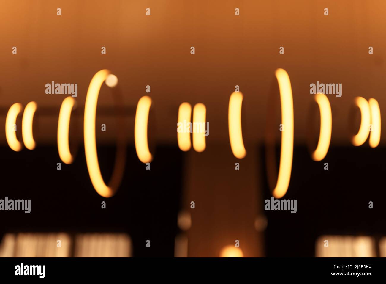 blurred hanging lamp bulb in the form of rings. blur beautiful abstract ...