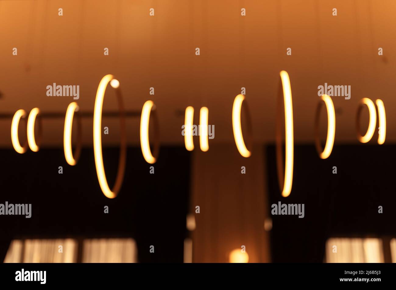 blurred hanging lamp bulb in the form of rings. blur beautiful abstract ...