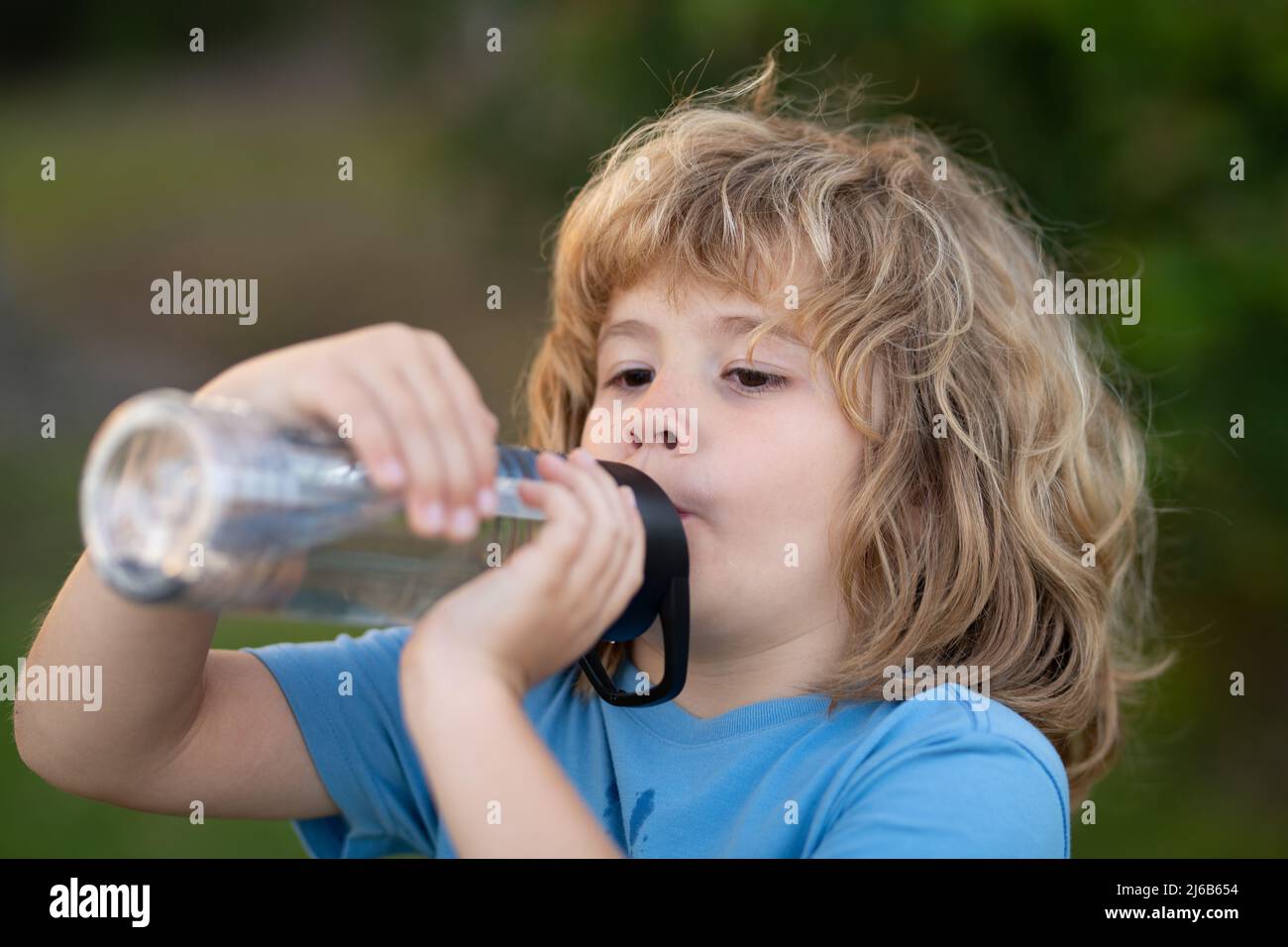 Child drinking water from bottle outdoor in park. Kid drinking Stock ...
