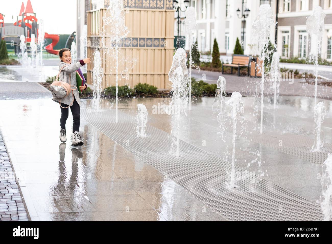happy little girl running home from school Stock Photo - Alamy