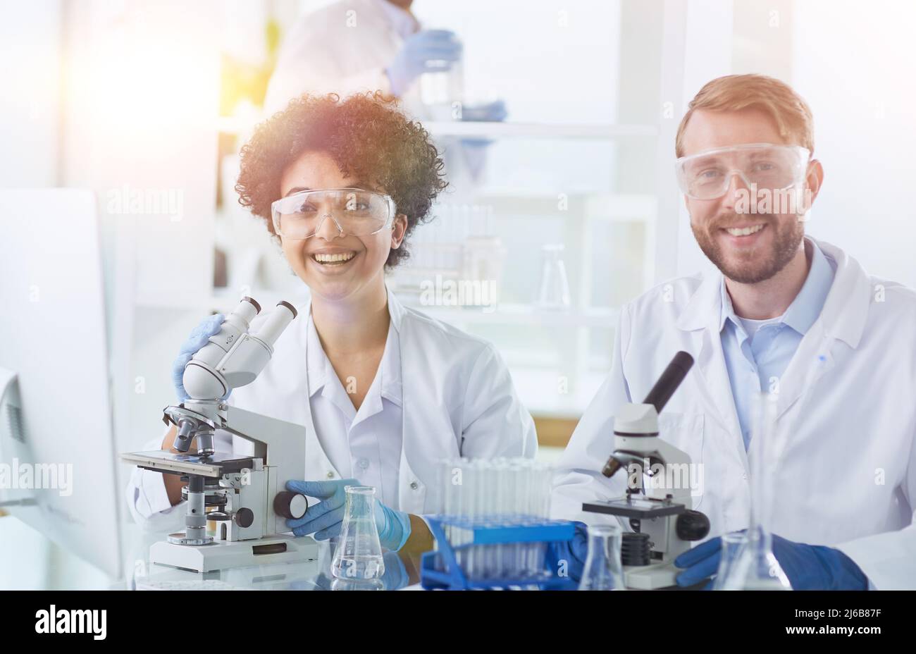 Smiling scientists looking at camera arms crossed in laboratory Stock ...