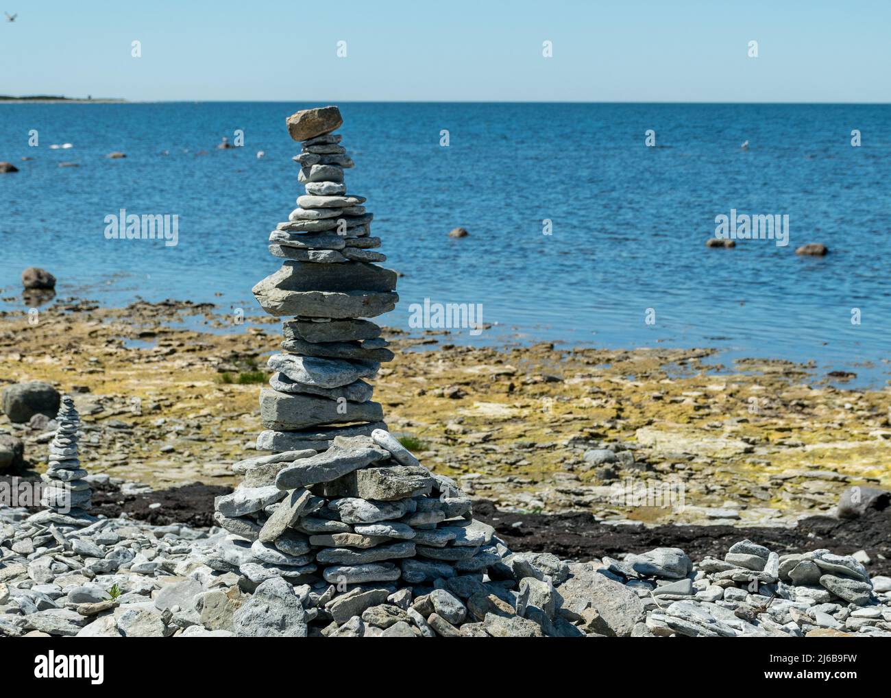 picture with beautiful white stone piles by the sea, these objects were ...