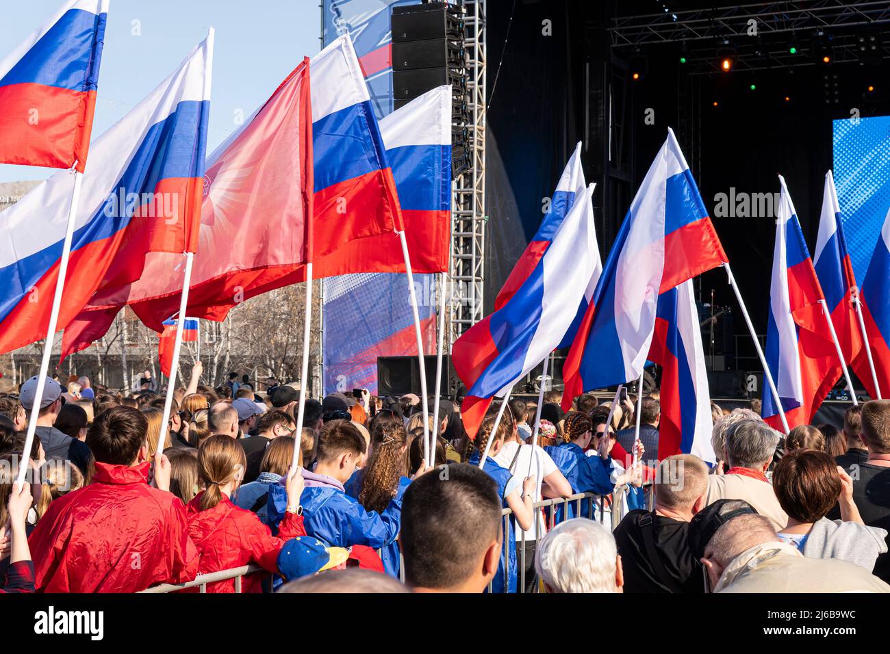 The Russian flag in a crowd of people. The audience at a street concert ...
