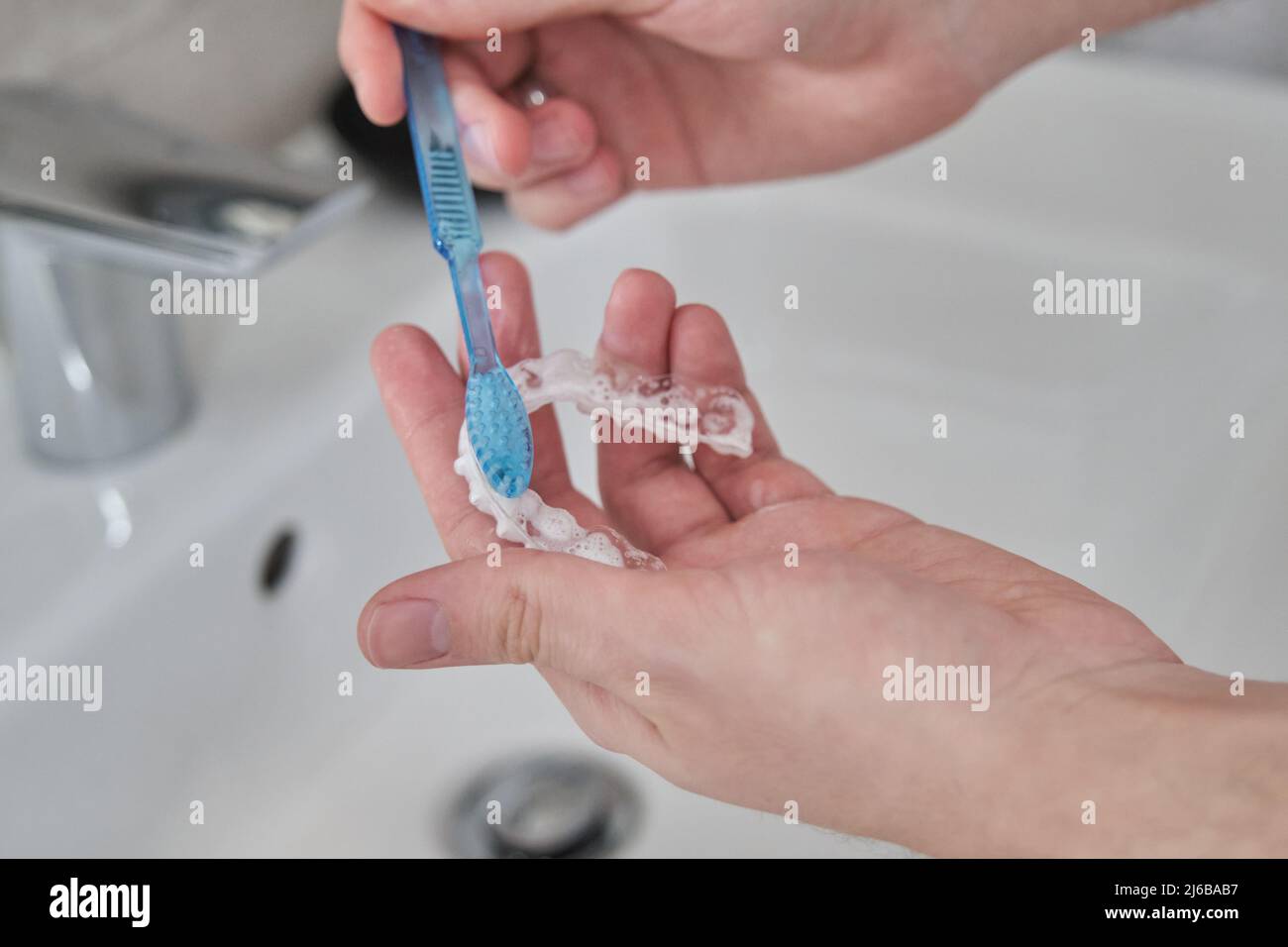 Washing with toothbrush and soap orthodontic invisible braces Stock ...
