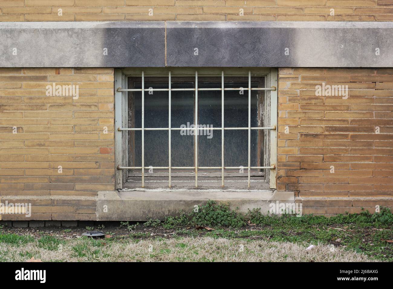 Vintage inner city basement window with a metal steel security grate ...
