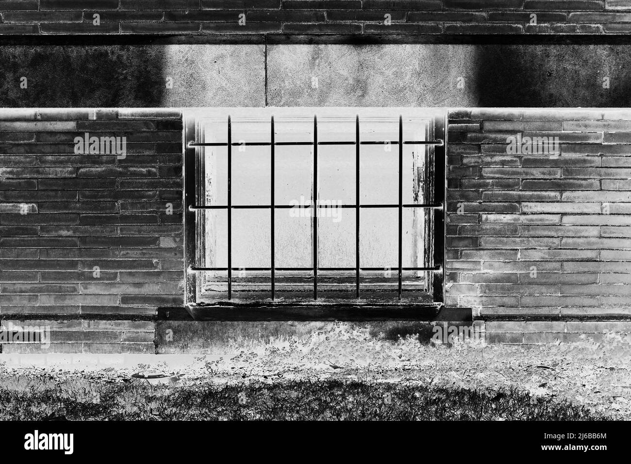 Vintage inner city basement window with a metal steel security grate in ...