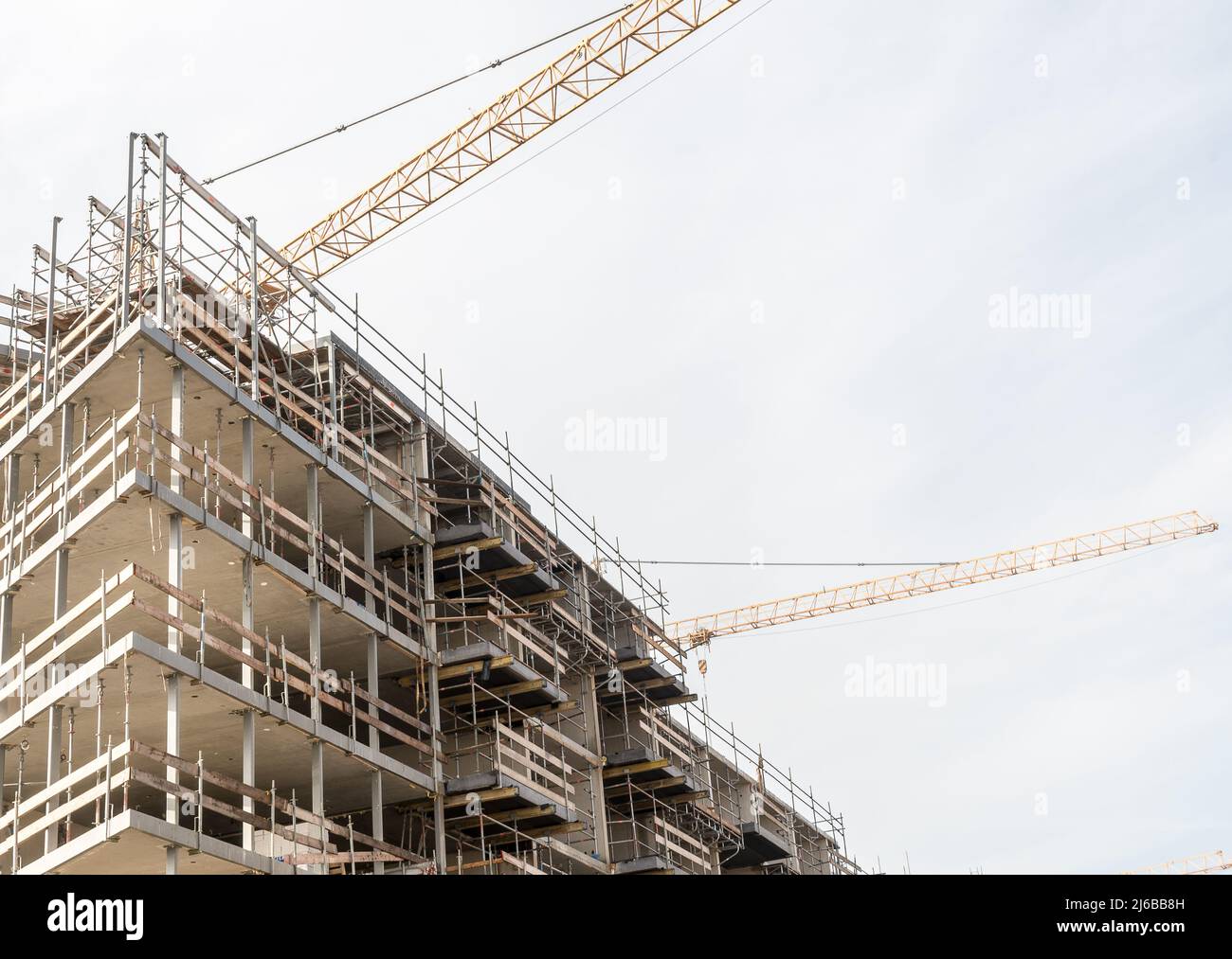 Building site with cranes and scaffolding Stock Photo - Alamy