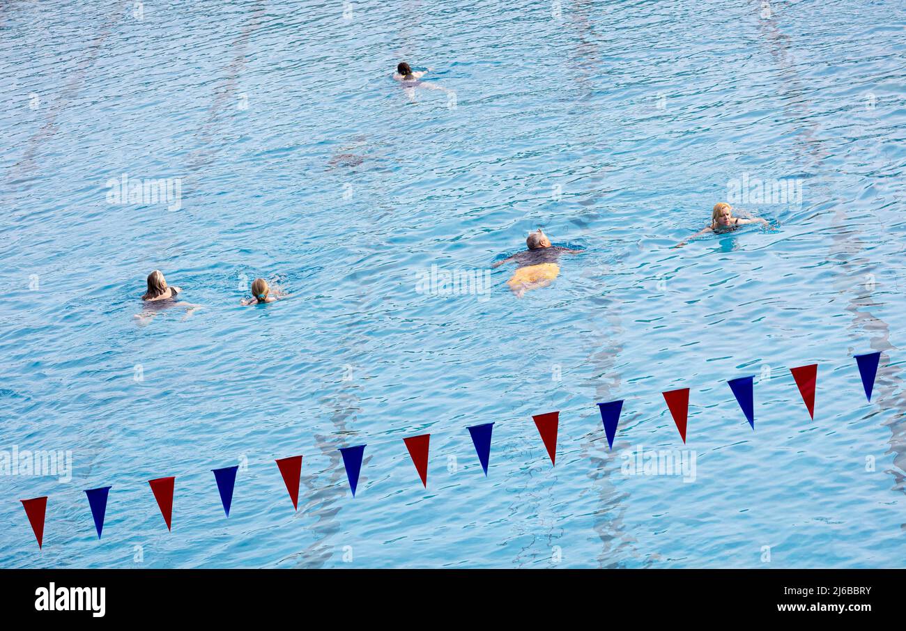 30 April 2022, Lower Saxony, Wolfsburg: Bathers swim in the pool from ...