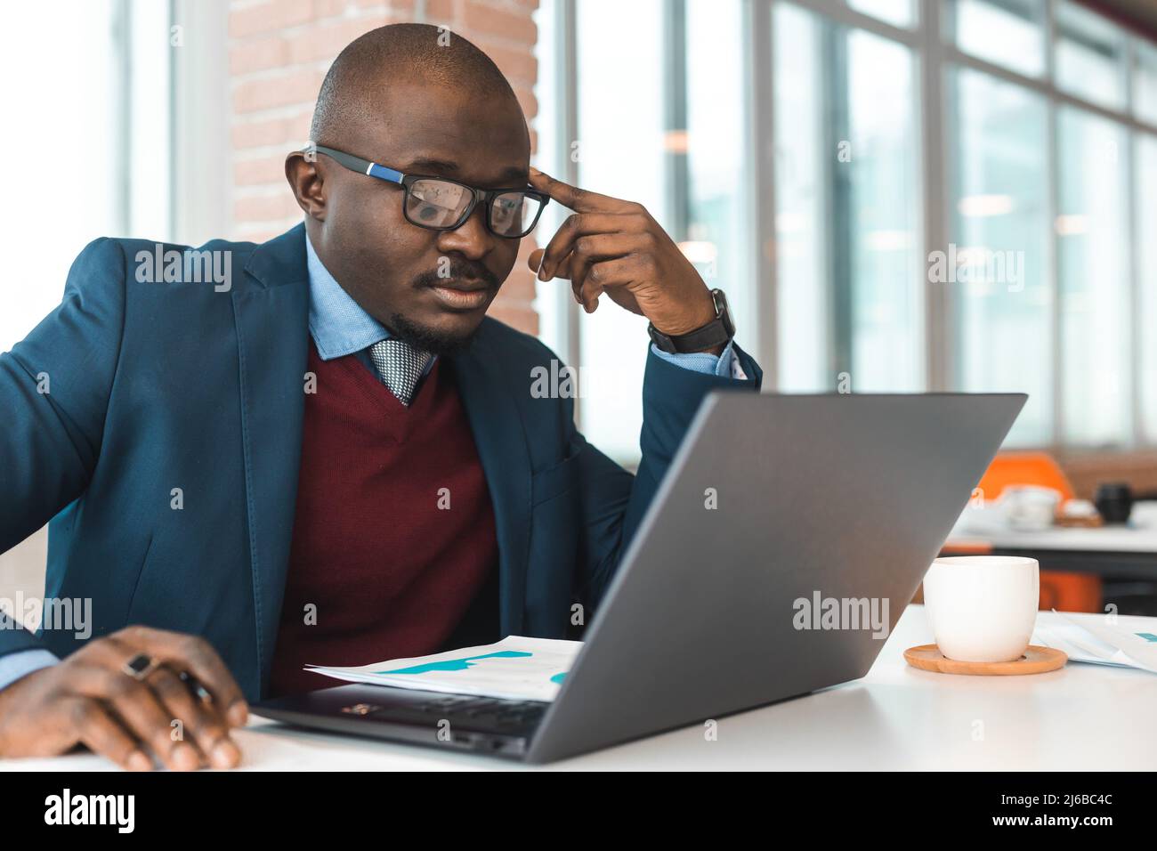 A black African American businessman in a business suit works at a ...
