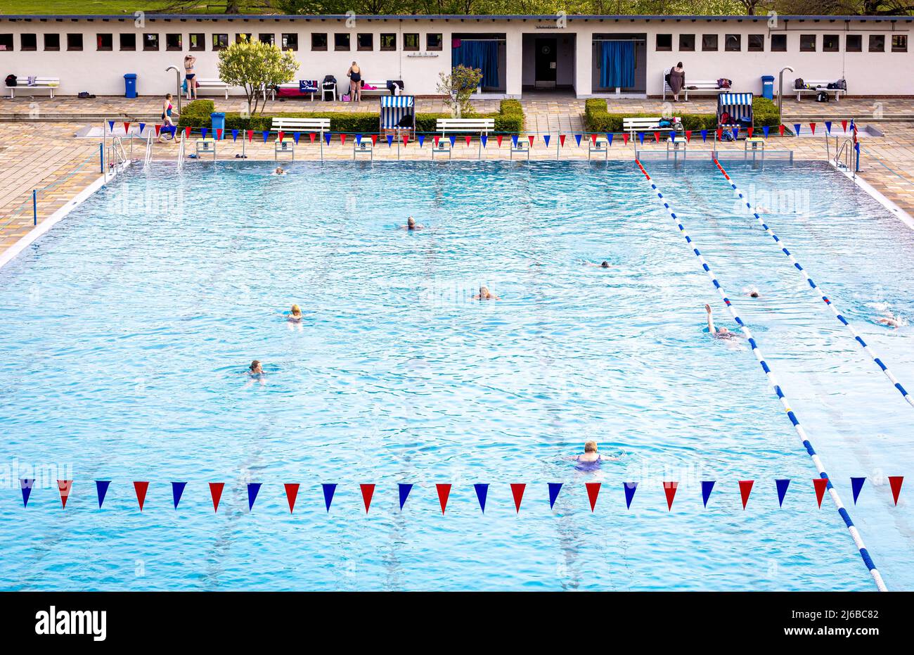 30 April 2022, Lower Saxony, Wolfsburg: Bathers swim in the pool from ...