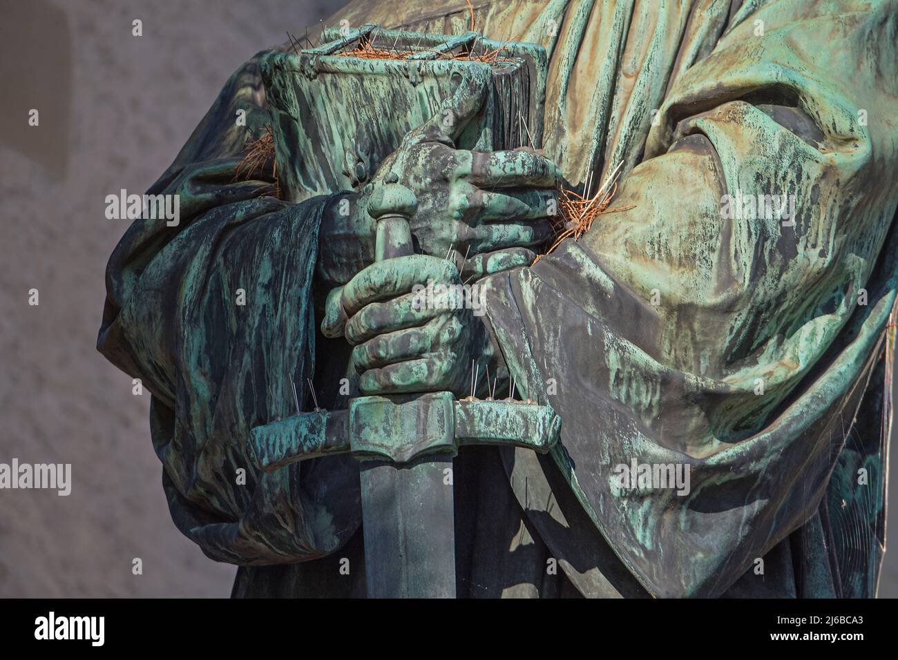 Detail of the bronze figure by Ulrich Zwingli (sword, hands, bible), at ...