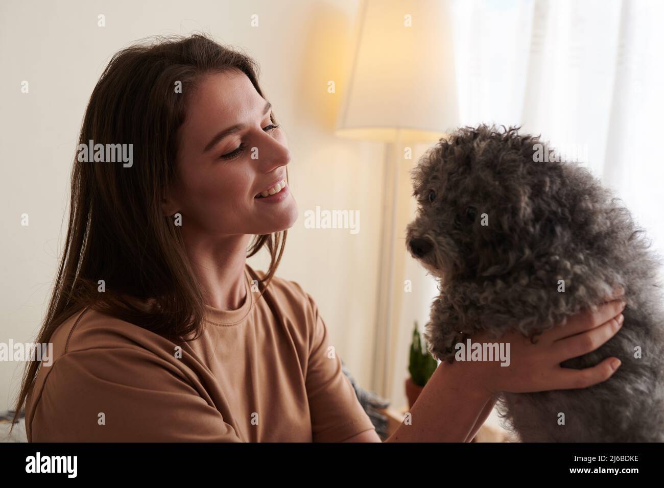 Happy woman interacting with dog, that helps relieve stresss, anxiety ... Happy woman interacting with dog, that helps relieve stresss, anxiety ...