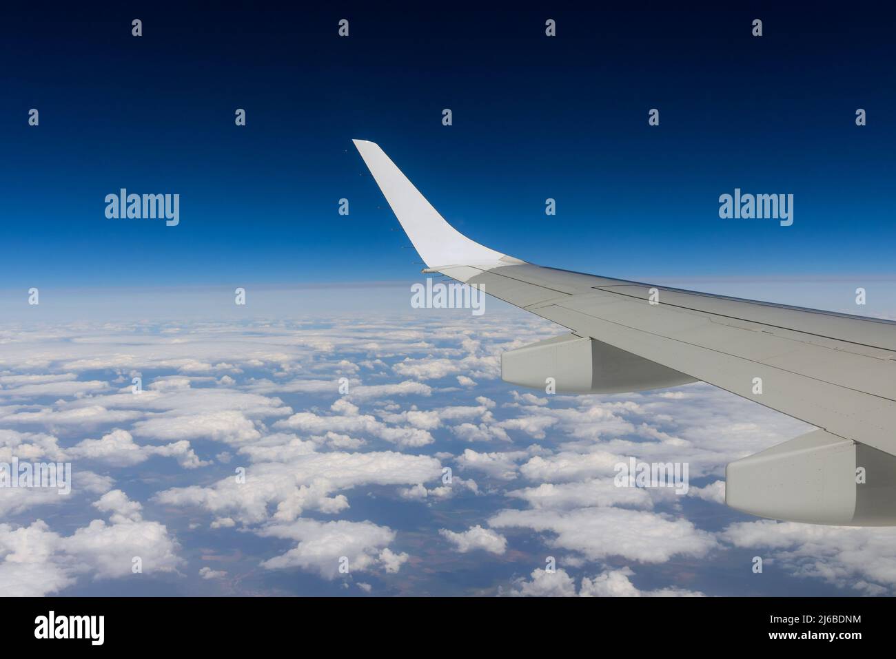 Wing on clouds blue sky with flying view from airplane window Stock ...