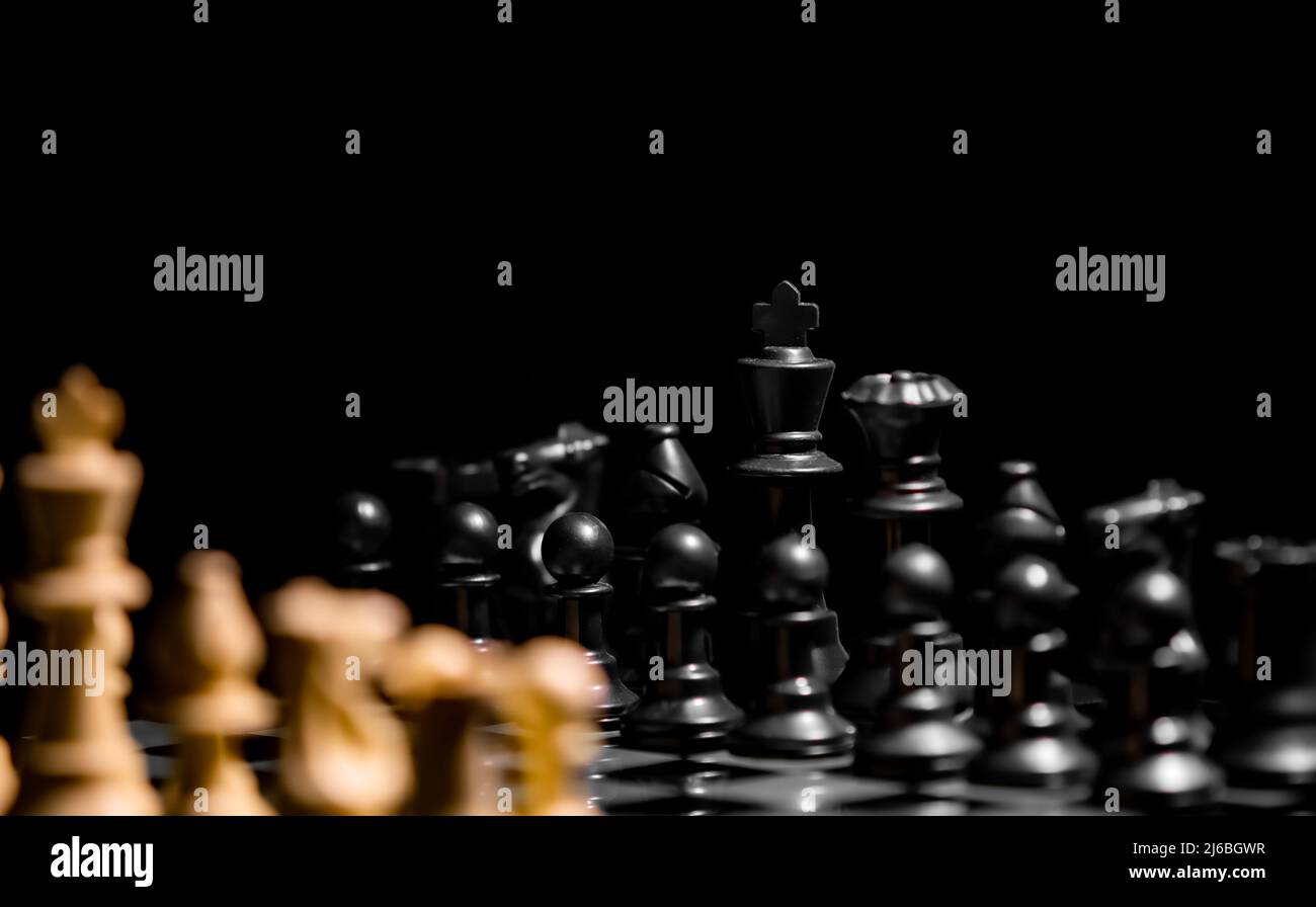 Close up of Chess pieces on a reflective mirror board surface with a ...