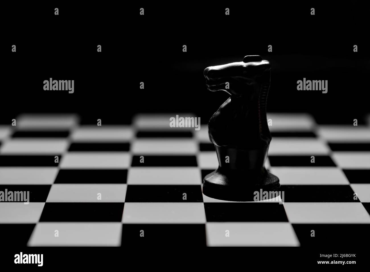 Close up of Chess pieces on a reflective mirror board surface with a ...