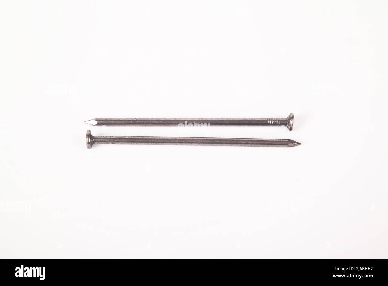 A lot of construction iron two nails, industrial parts, isolated on ...