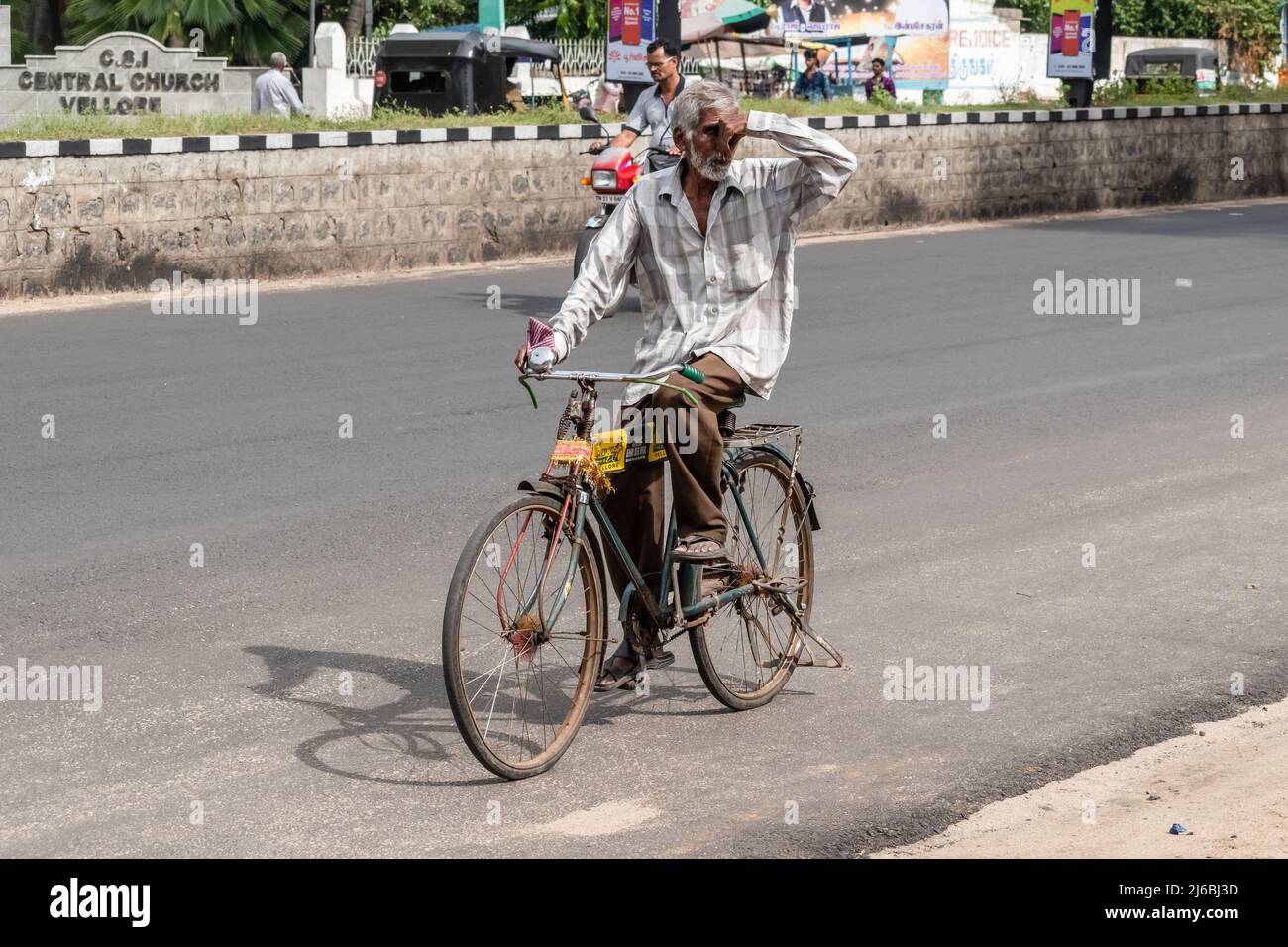 Indian old man riding bicycle hi-res stock photography and images - Alamy