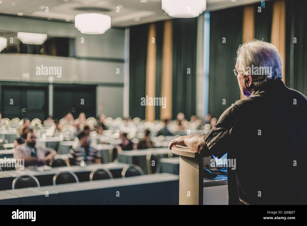 Senior public speaker giving talk at scientific conference Stock Photo ...