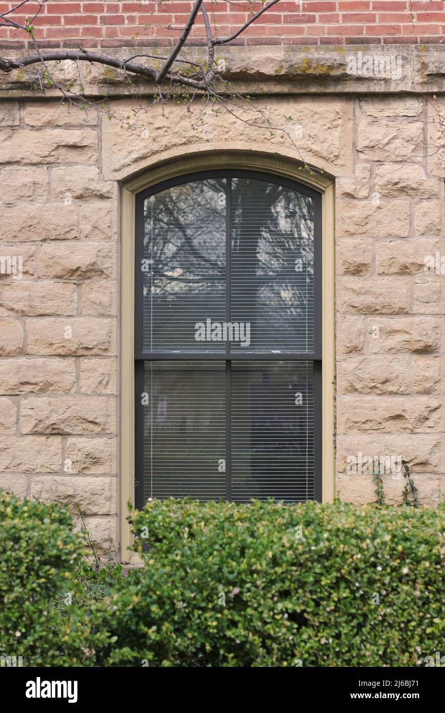 A traditional colonial window set inside a stone wall Stock Photo - Alamy