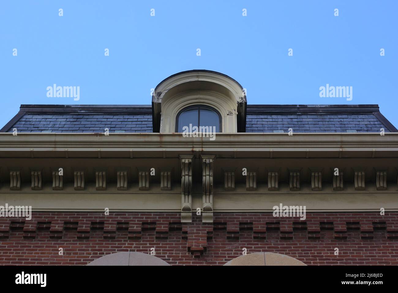 A traditional colonial rooftop cornice with an attic window Stock Photo ...
