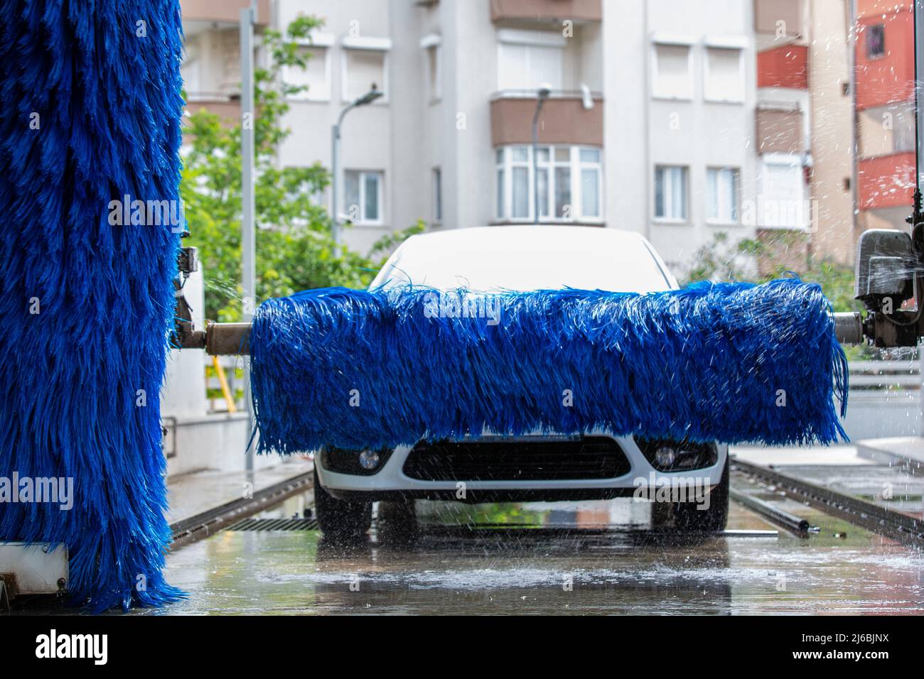 Washing the car in an automatic washing machine. Brushed Car Washing ...