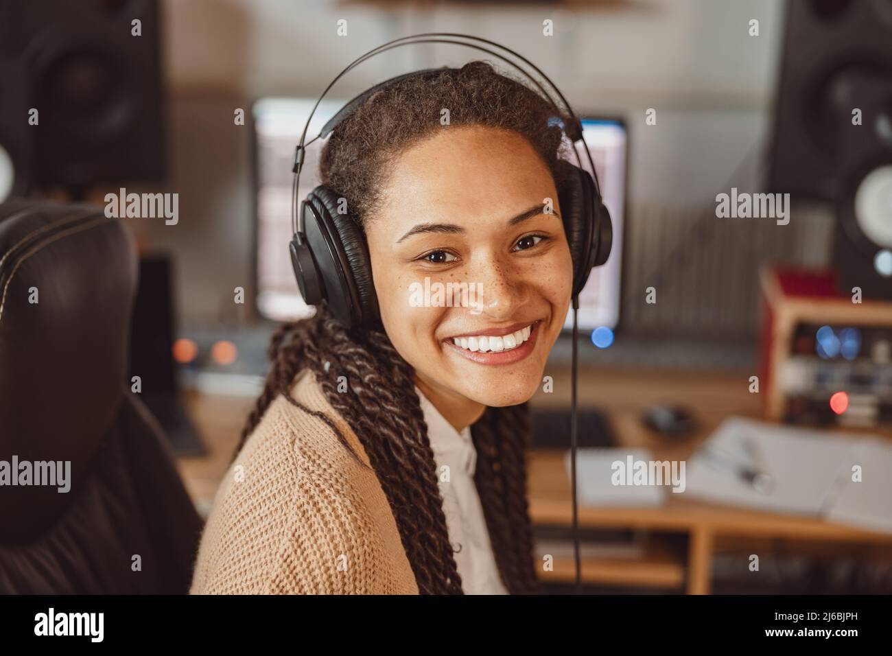 Young African composer musician with headphones in recording studio ...