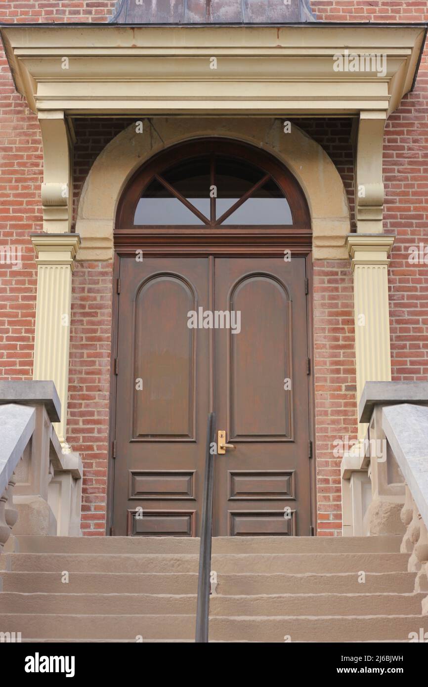 A traditional colonial entry with closed wooden doors Stock Photo - Alamy