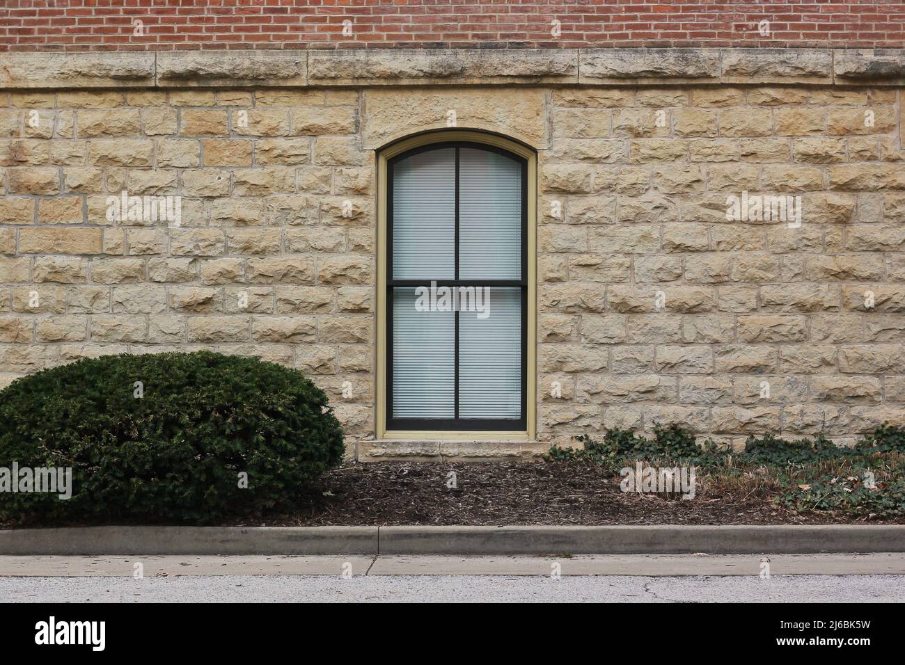 A traditional colonial window set inside a stone wall Stock Photo - Alamy