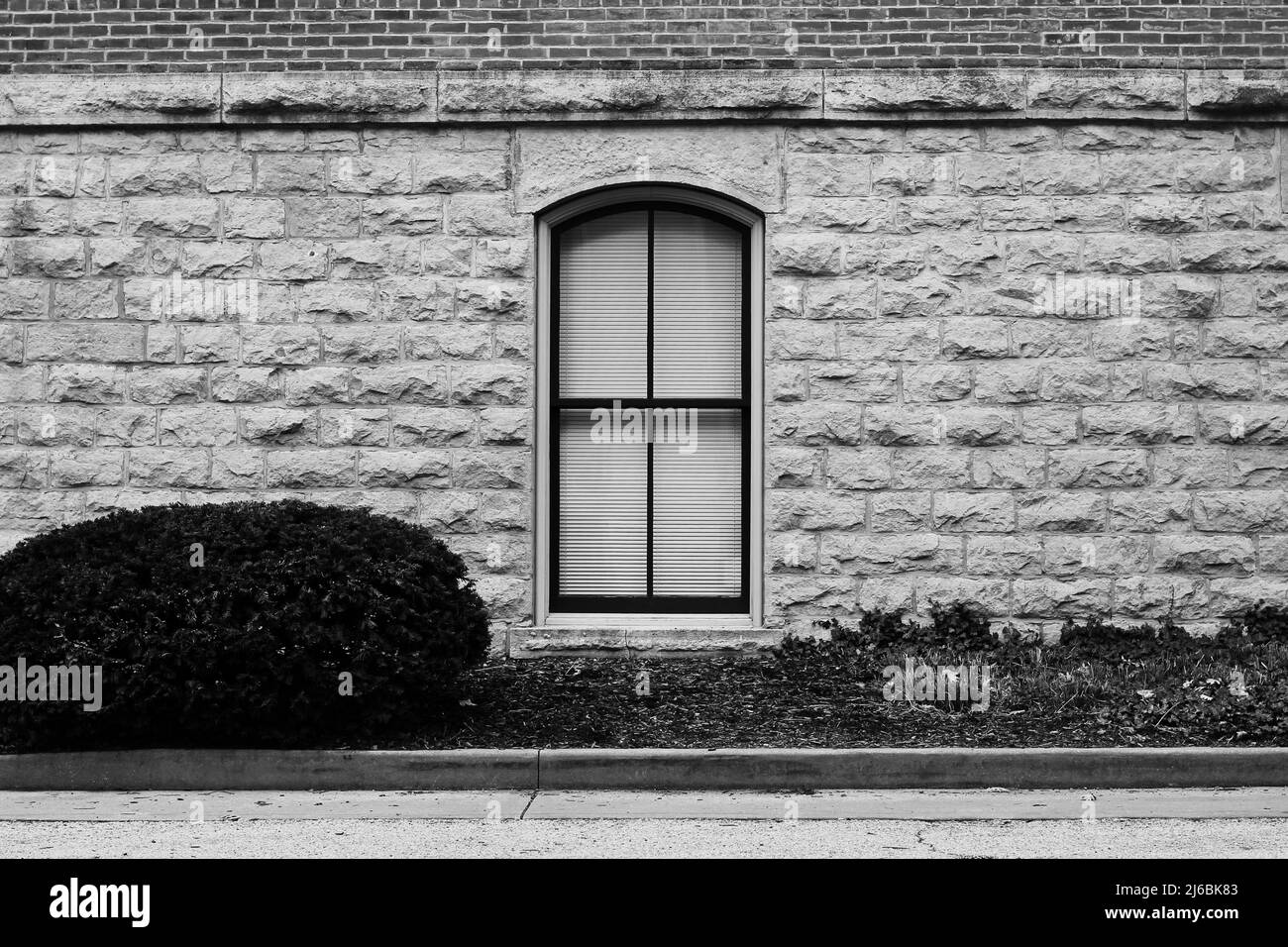 A traditional colonial window set inside a stone wall Stock Photo - Alamy