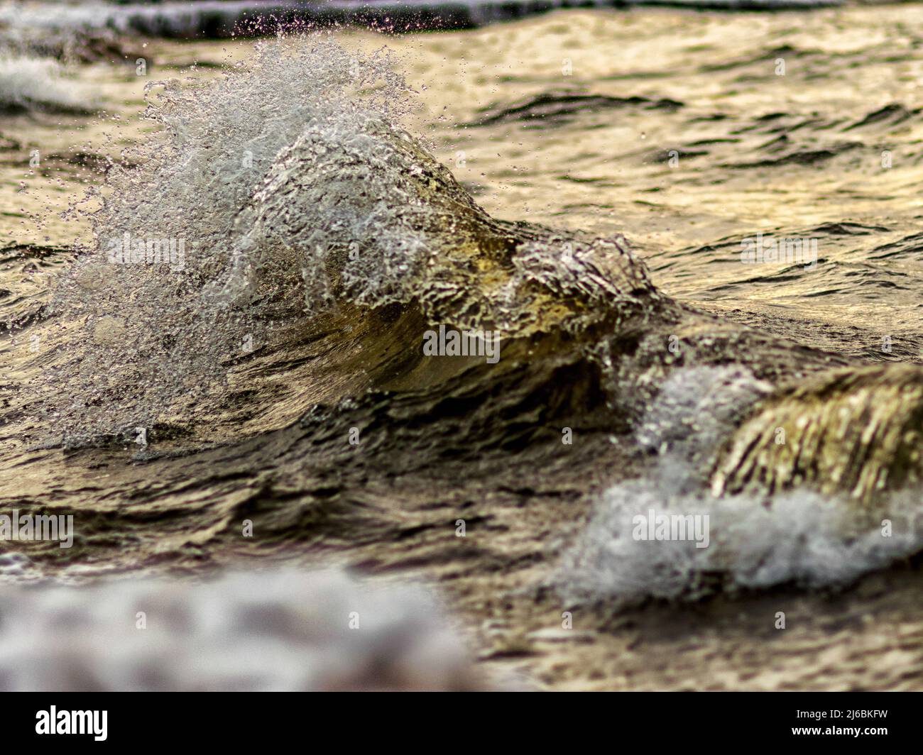 winter landscape from the sea shore, blurred wave slag against frozen ...