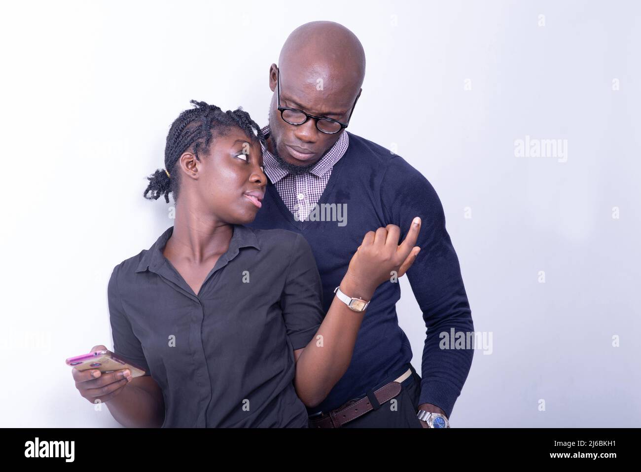 curious man looking over woman's shoulder chatting on the phone Stock ...