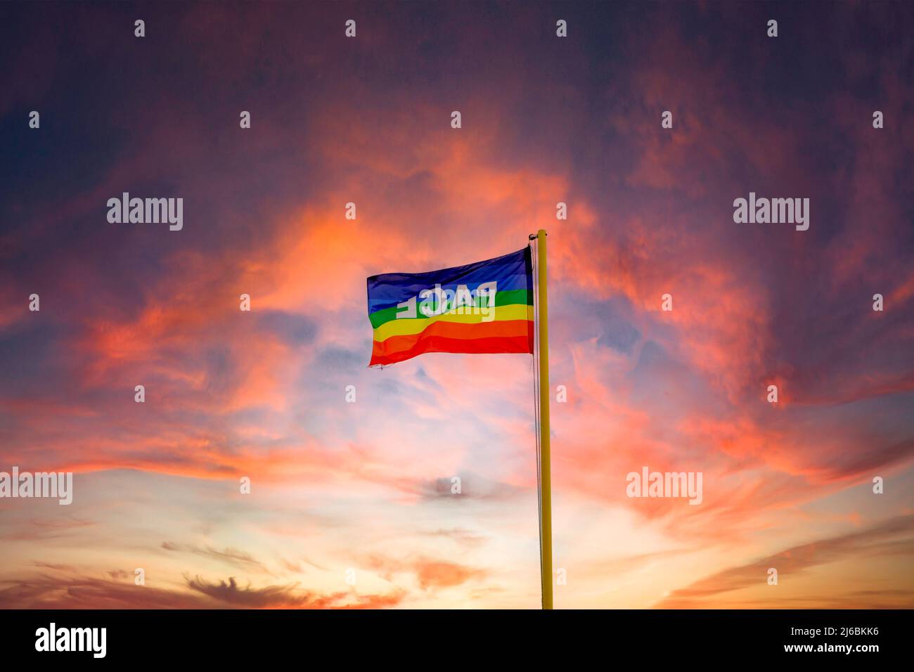 The flag in the colors of peace flutters against the backdrop of a ...