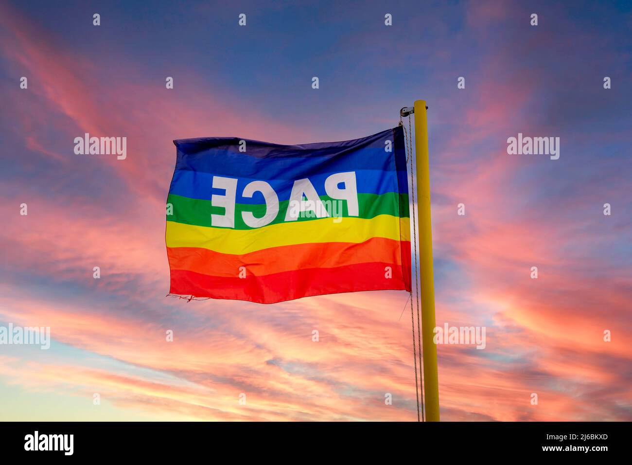 The flag in the colors of peace flutters against the backdrop of a ...