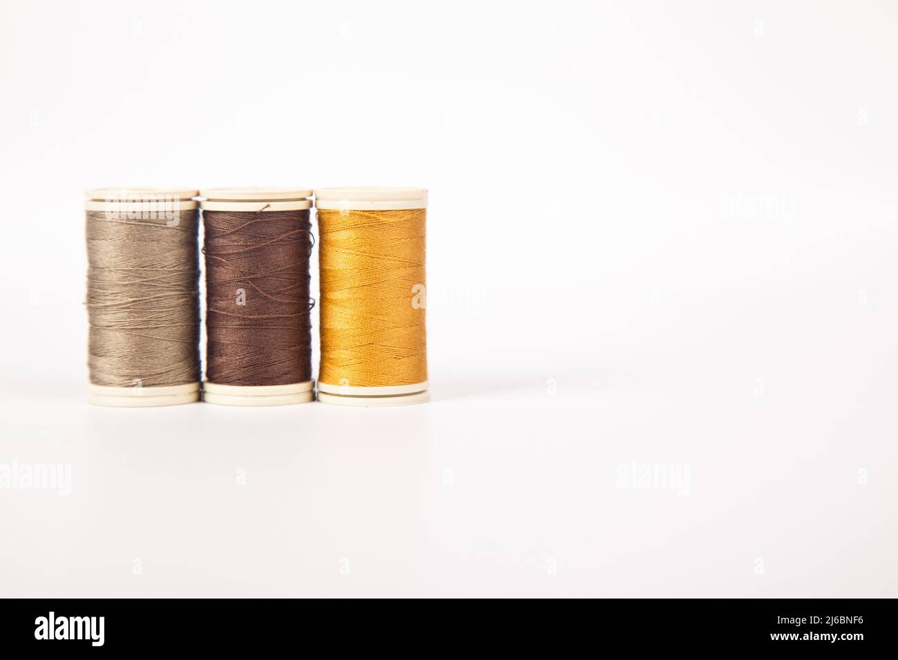 Spools and bobbins of thread for sewing in different colors, isolated ...