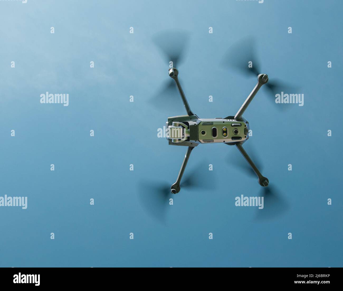The image of the drone flying in the air taken from the ground at a ...