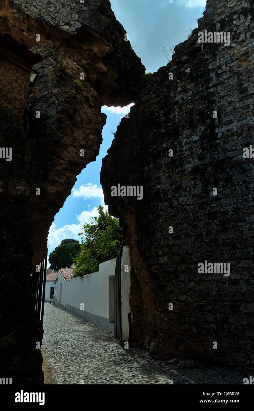 Serpa Castle entrance with the iconic ruins of its keep tower. Alentejo ...