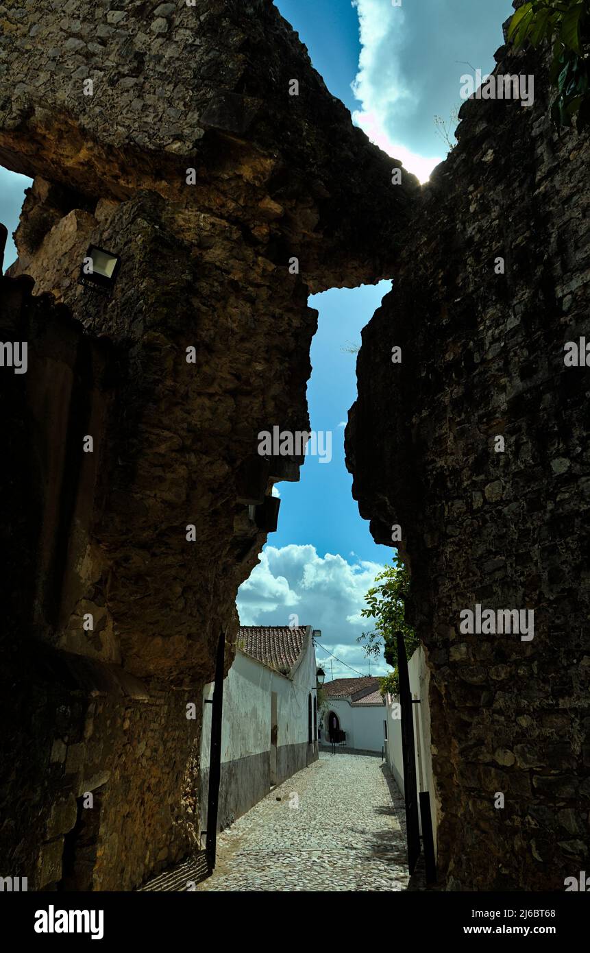 Serpa Castle entrance with the iconic ruins of its keep tower. Alentejo ...