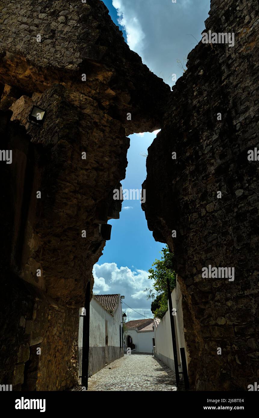 Serpa Castle entrance with the iconic ruins of its keep tower. Alentejo ...