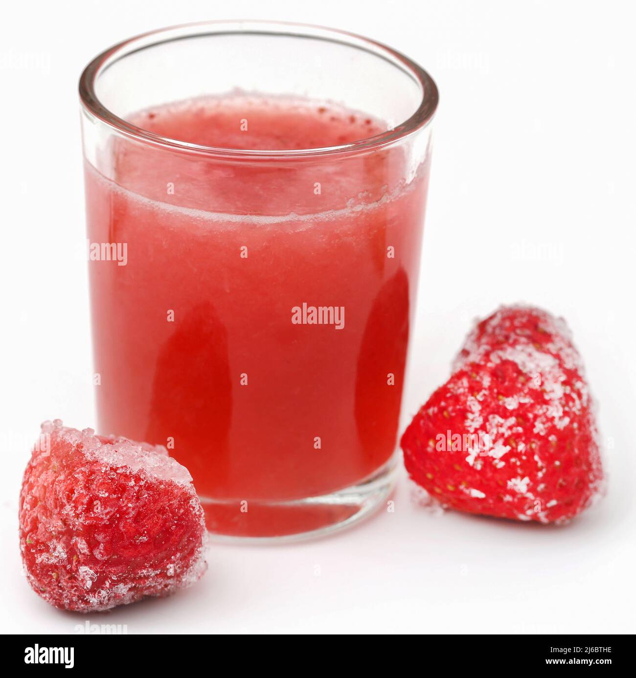 Strawberry juice in a glass with frozen fruits Stock Photo - Alamy