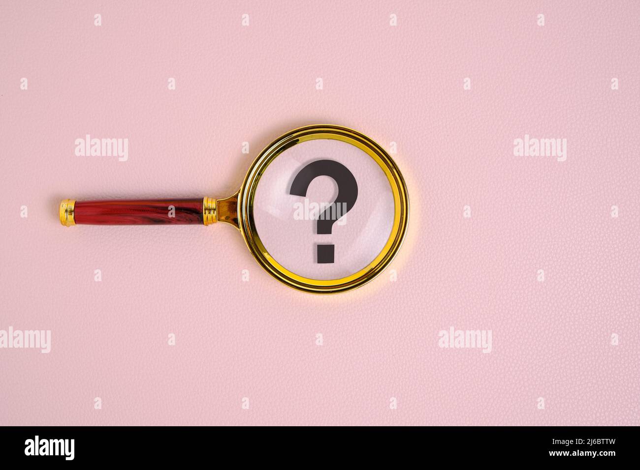 Question mark under magnifying glass, on pink background Stock Photo ...