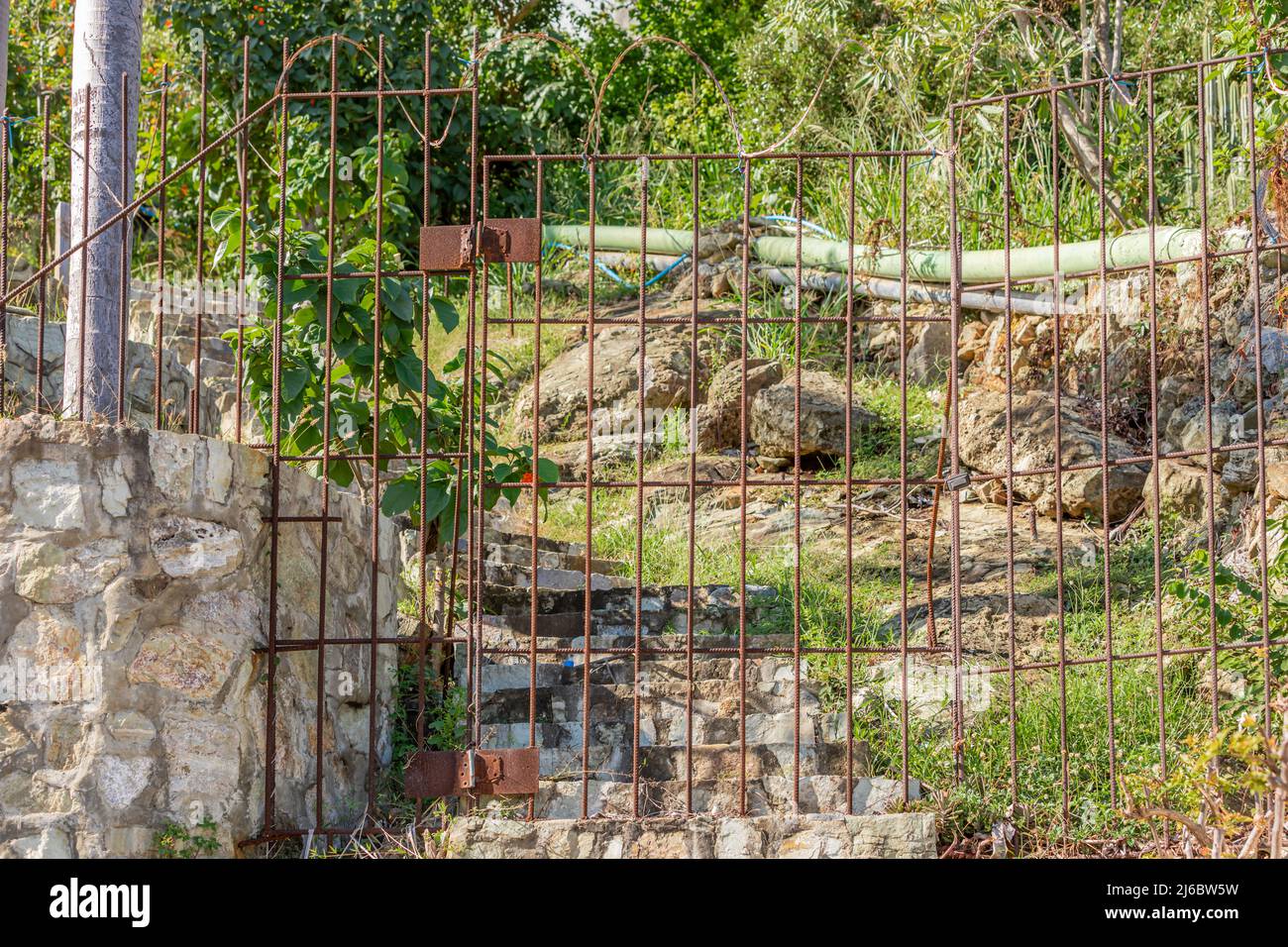 Old rusted gate and steps in St Maarten Stock Photo - Alamy