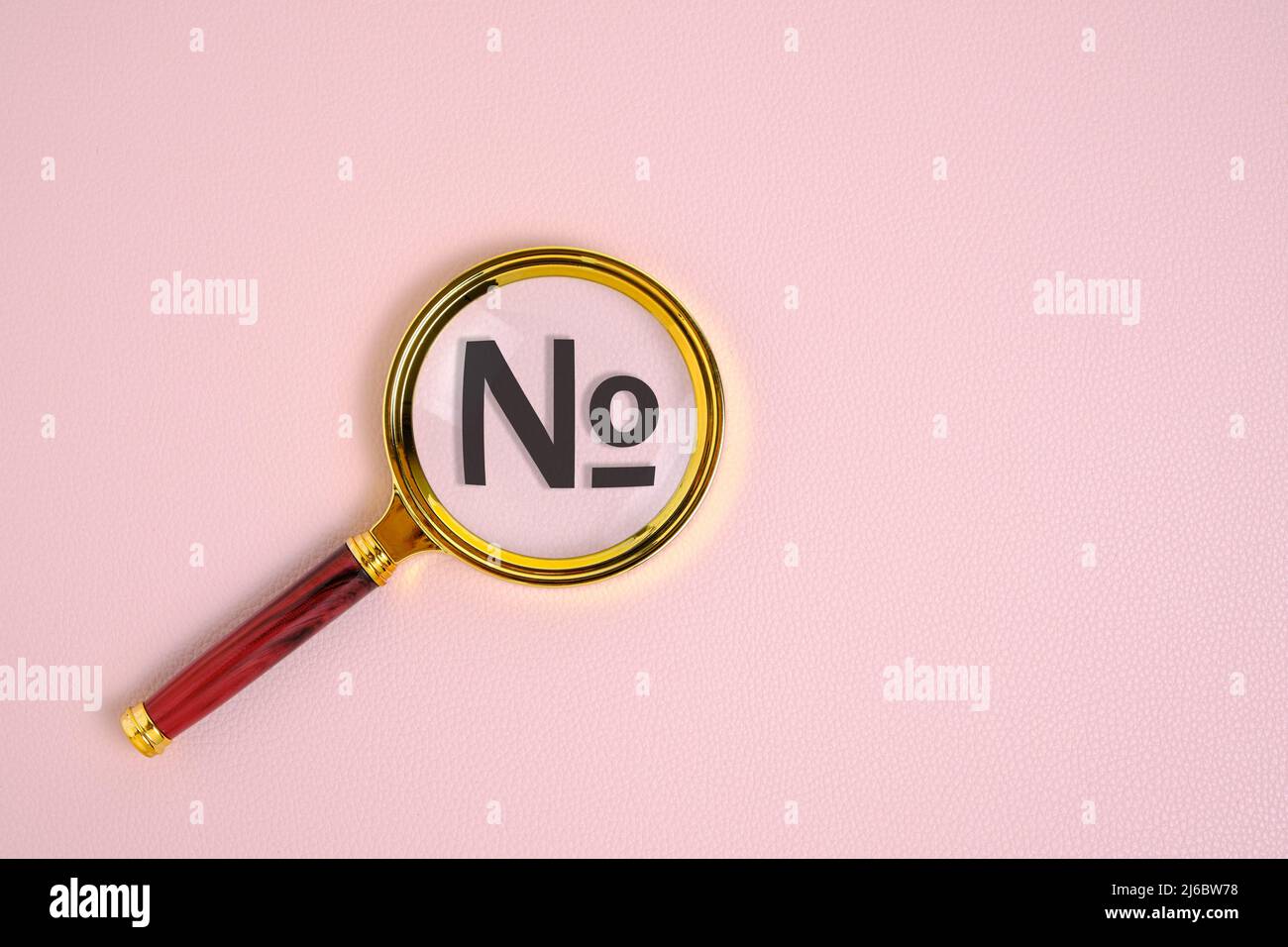 Sign No. under magnifying glass, on pink background Stock Photo - Alamy