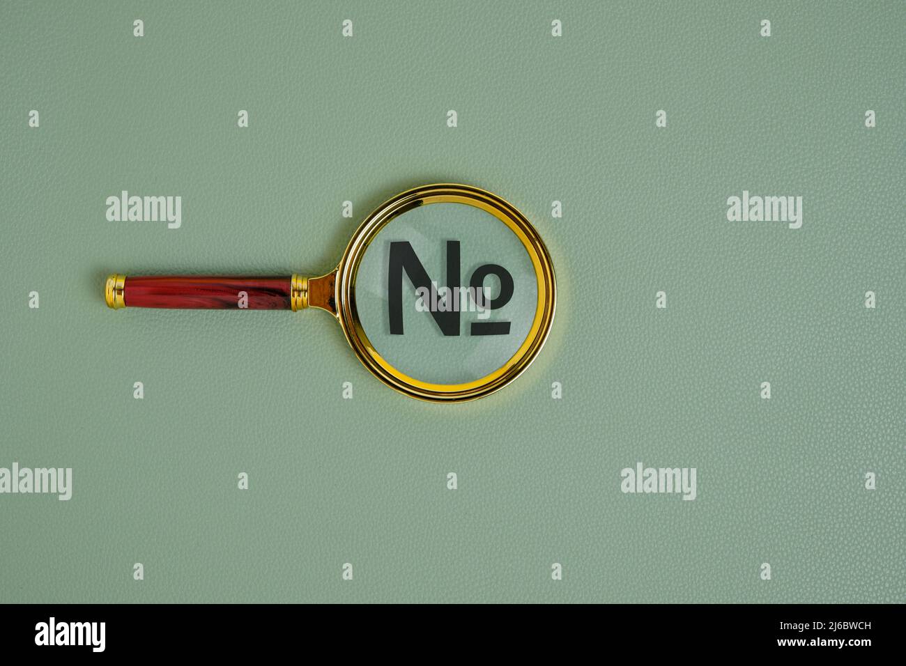 Sign No. under magnifying glass, on green background Stock Photo - Alamy
