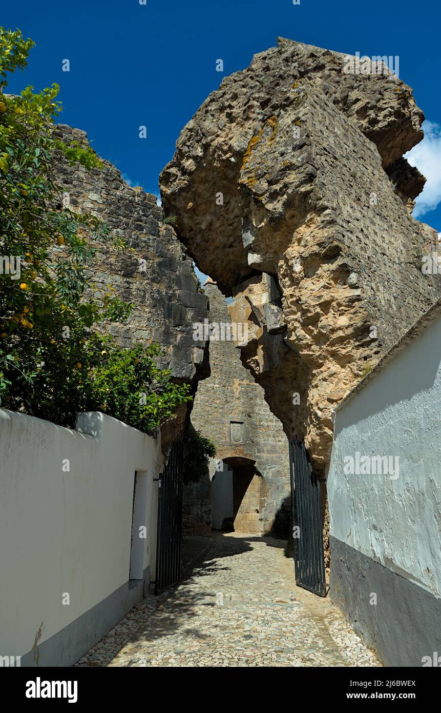 Serpa Castle entrance with the iconic ruins of its keep tower. Alentejo ...