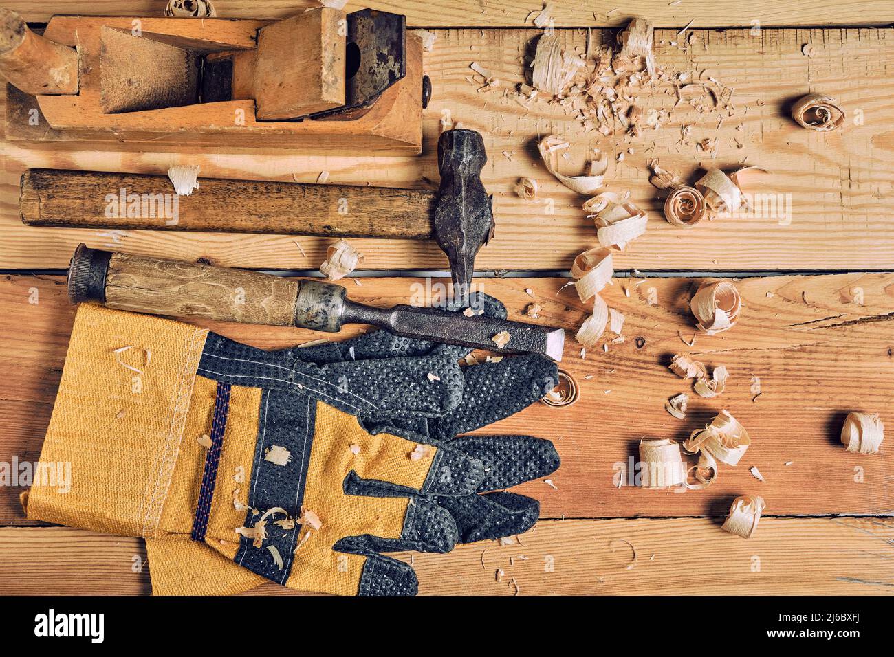 Carpenters tool kit, hammer, chisel and plane with gloves wooden ...