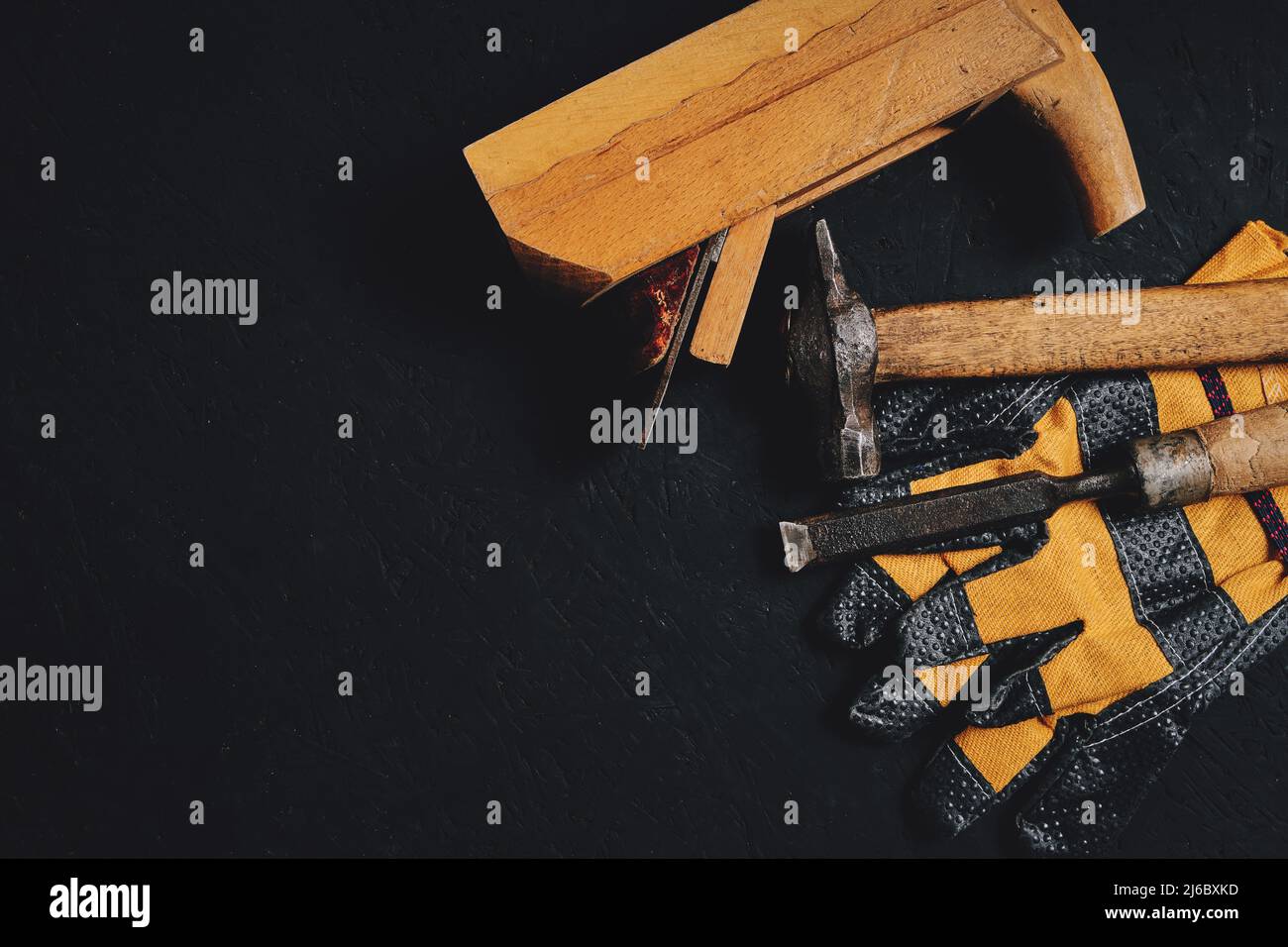 Set of tools for carpenters, hammer, chisel and plane with gloves dark ...