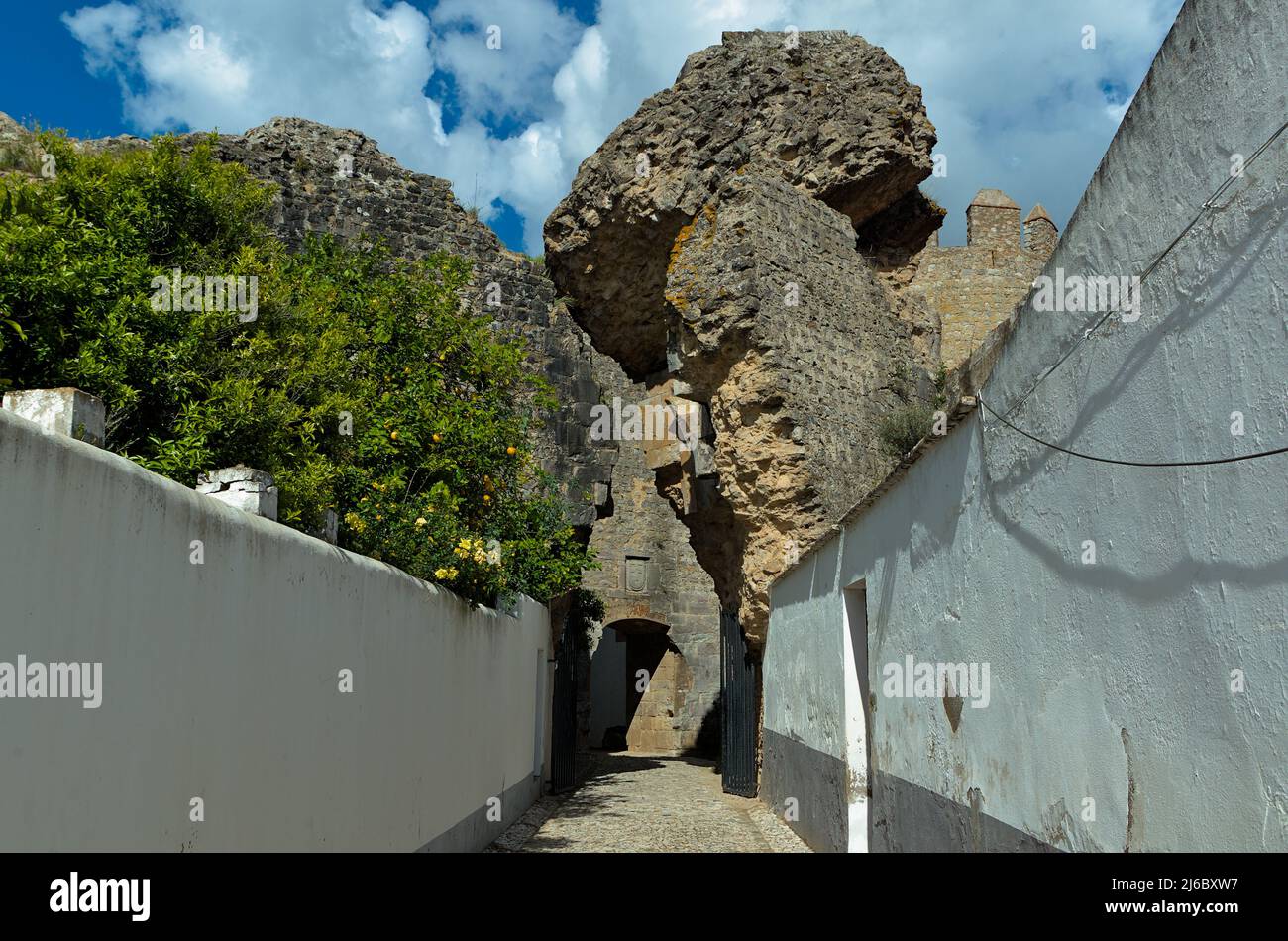 Serpa Castle entrance with the iconic ruins of its keep tower. Alentejo ...