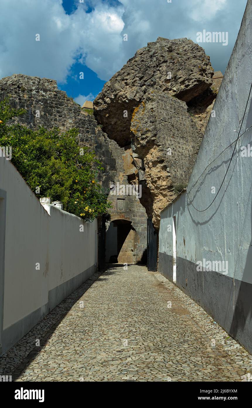 Serpa Castle entrance with the iconic ruins of its keep tower. Alentejo ...